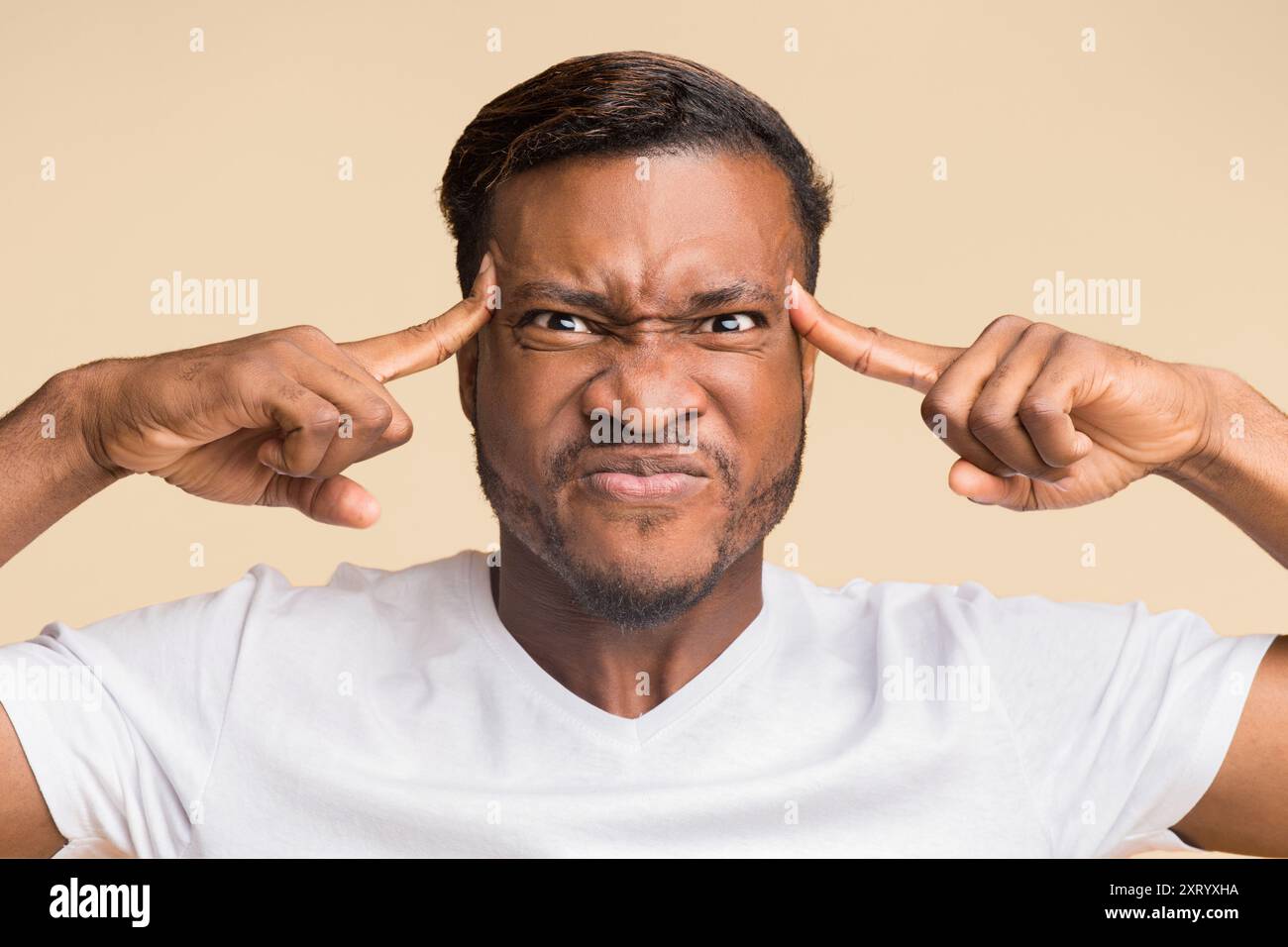 Black Man Concentrating Hard Pointing Fingers At Forehead In Studio ...