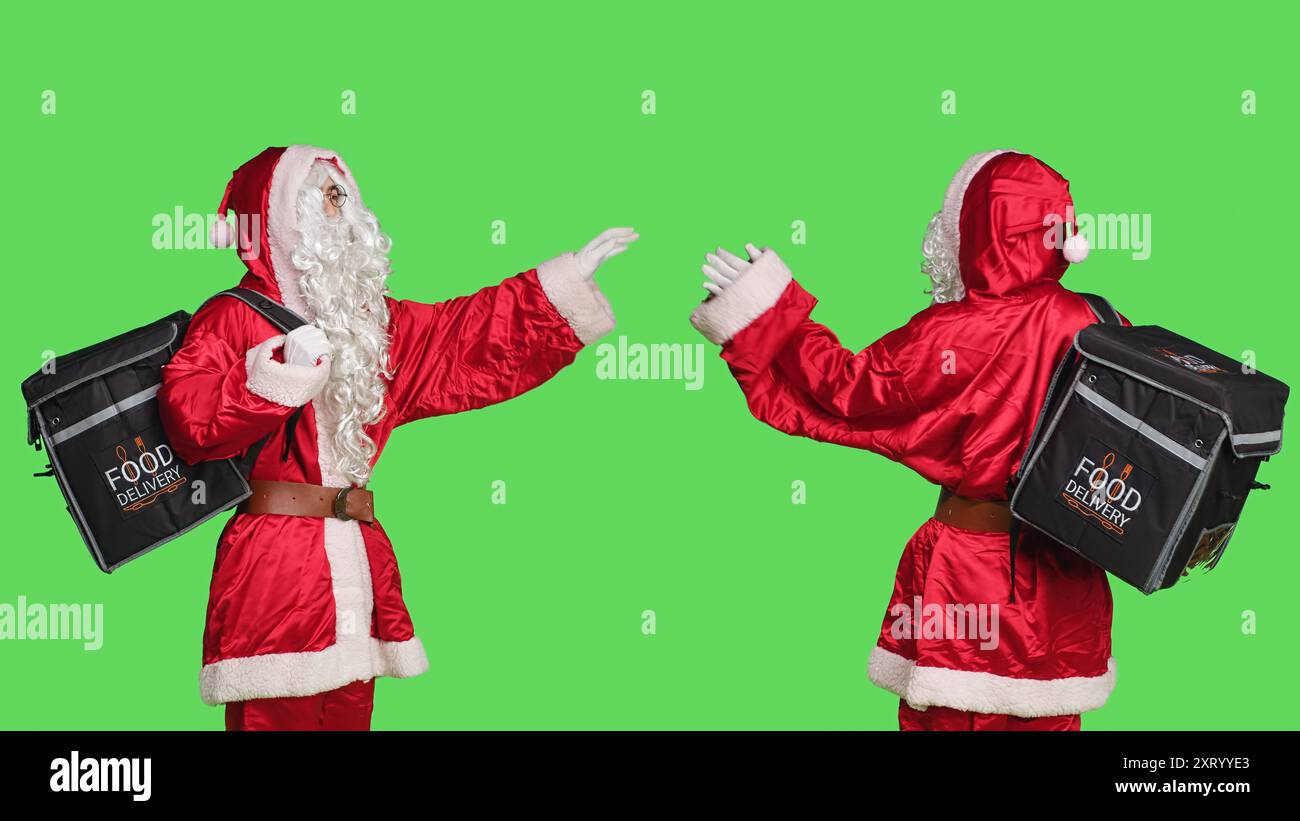 Man in santa suit with delivery backpack over greenscreen background ...