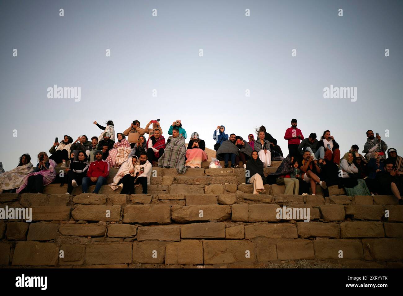 Visitors watch the sunrise after the Perseid meteor shower atop Mount ...