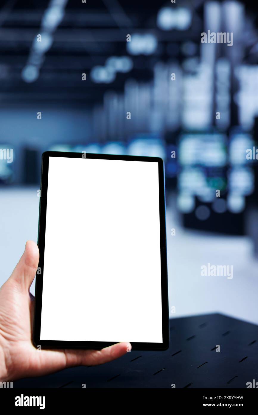 Experienced admin using mock up tablet to check operational server cabinets. Rigs in computer ...