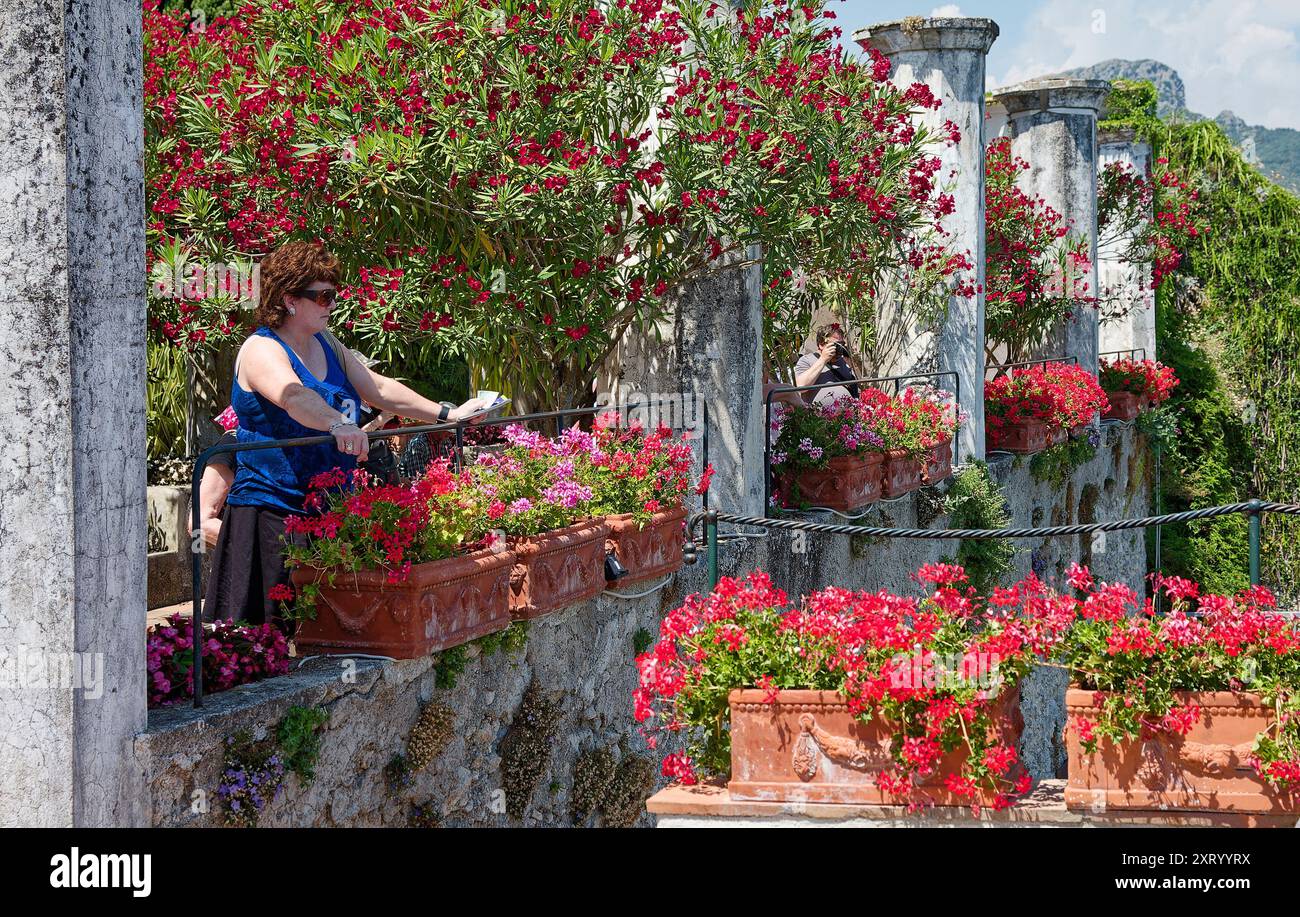 stone balcony, rose red flowers, terra cotta flower boxes, pillars ...