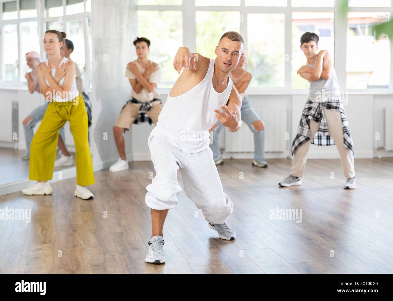 Young guy dancing hip-hop against background of group members Stock ...