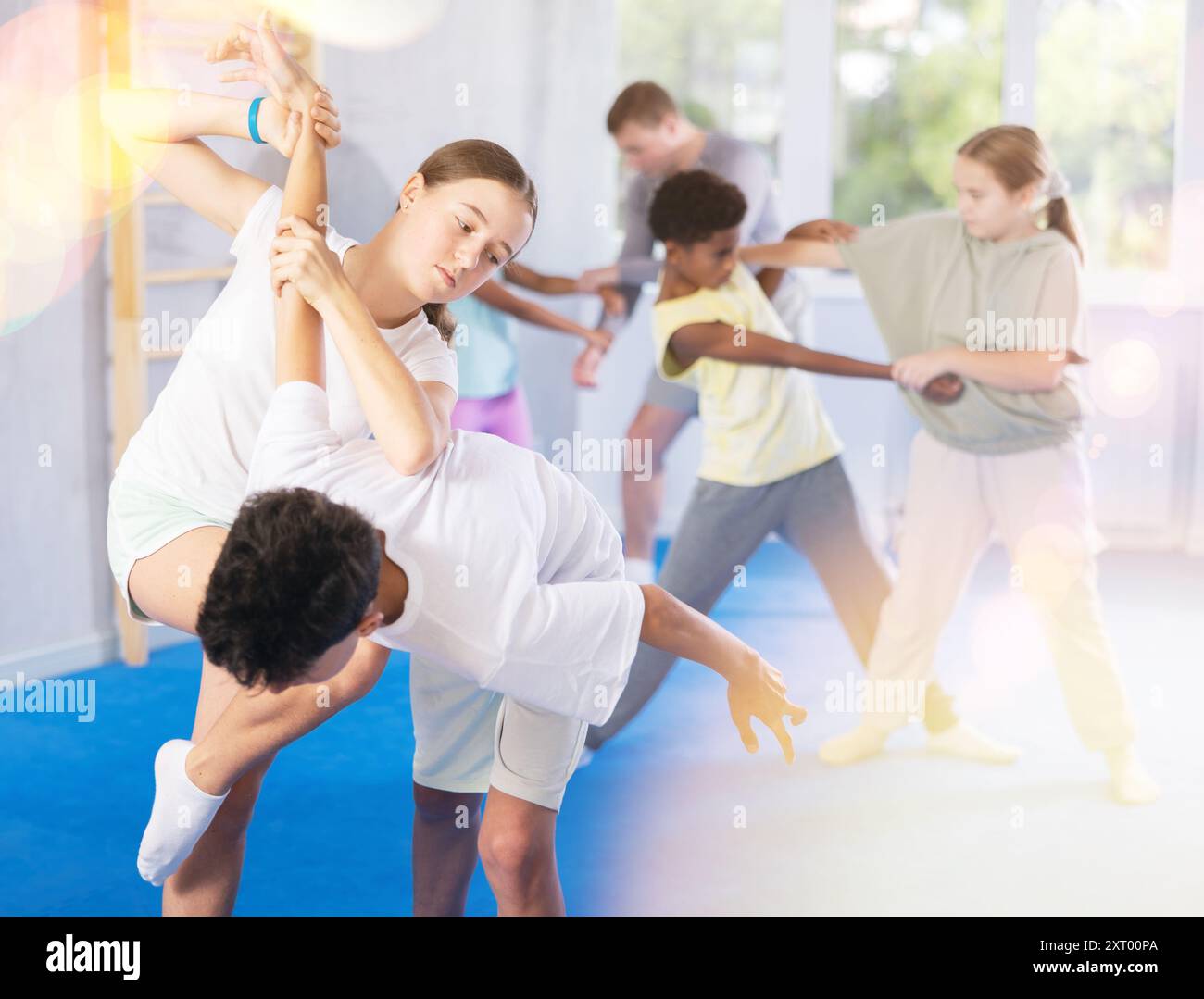 Tween girl practicing wristlock with elbow and knee blows in training ...
