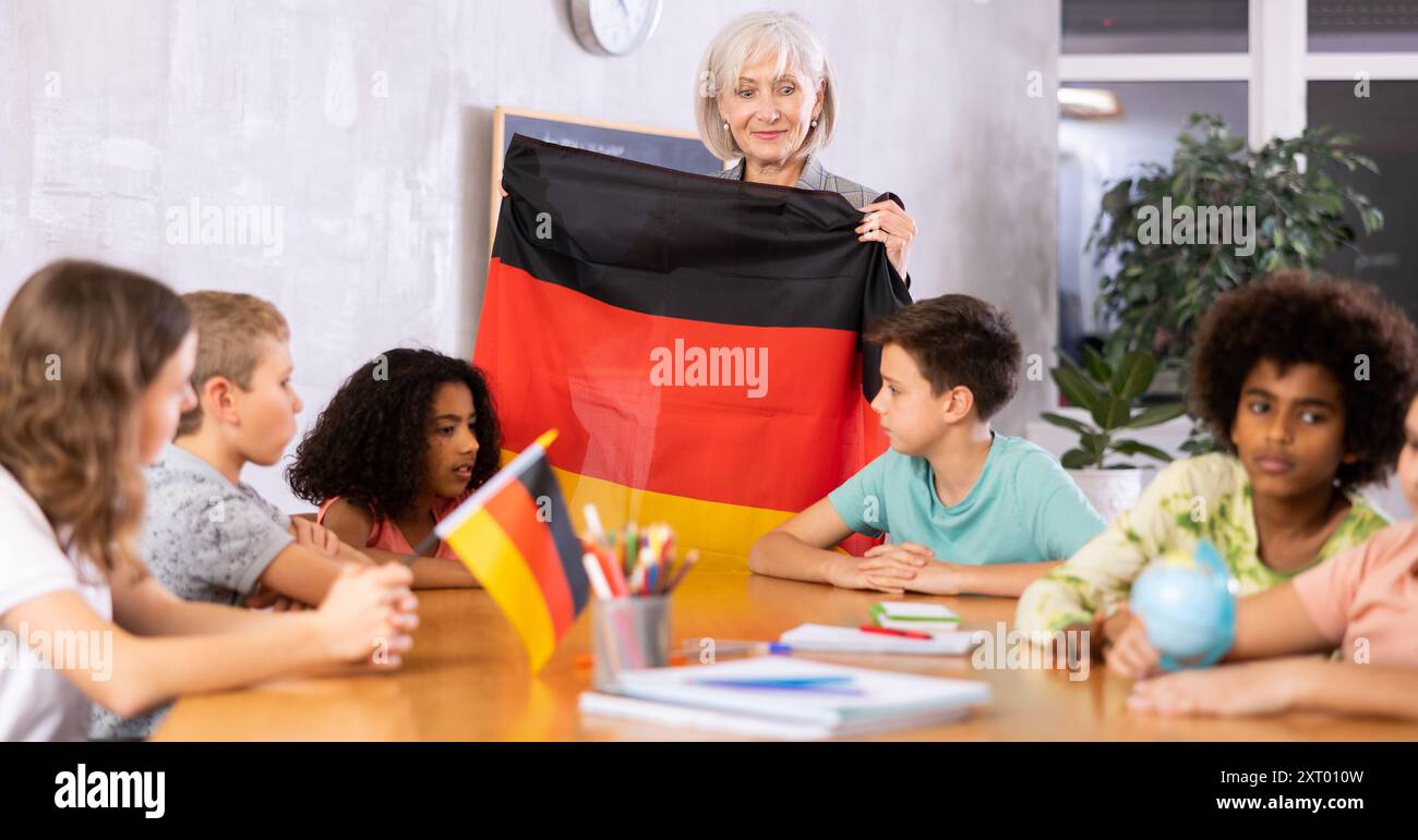 Female teacher showing german to kids in geography class Stock Photo ...