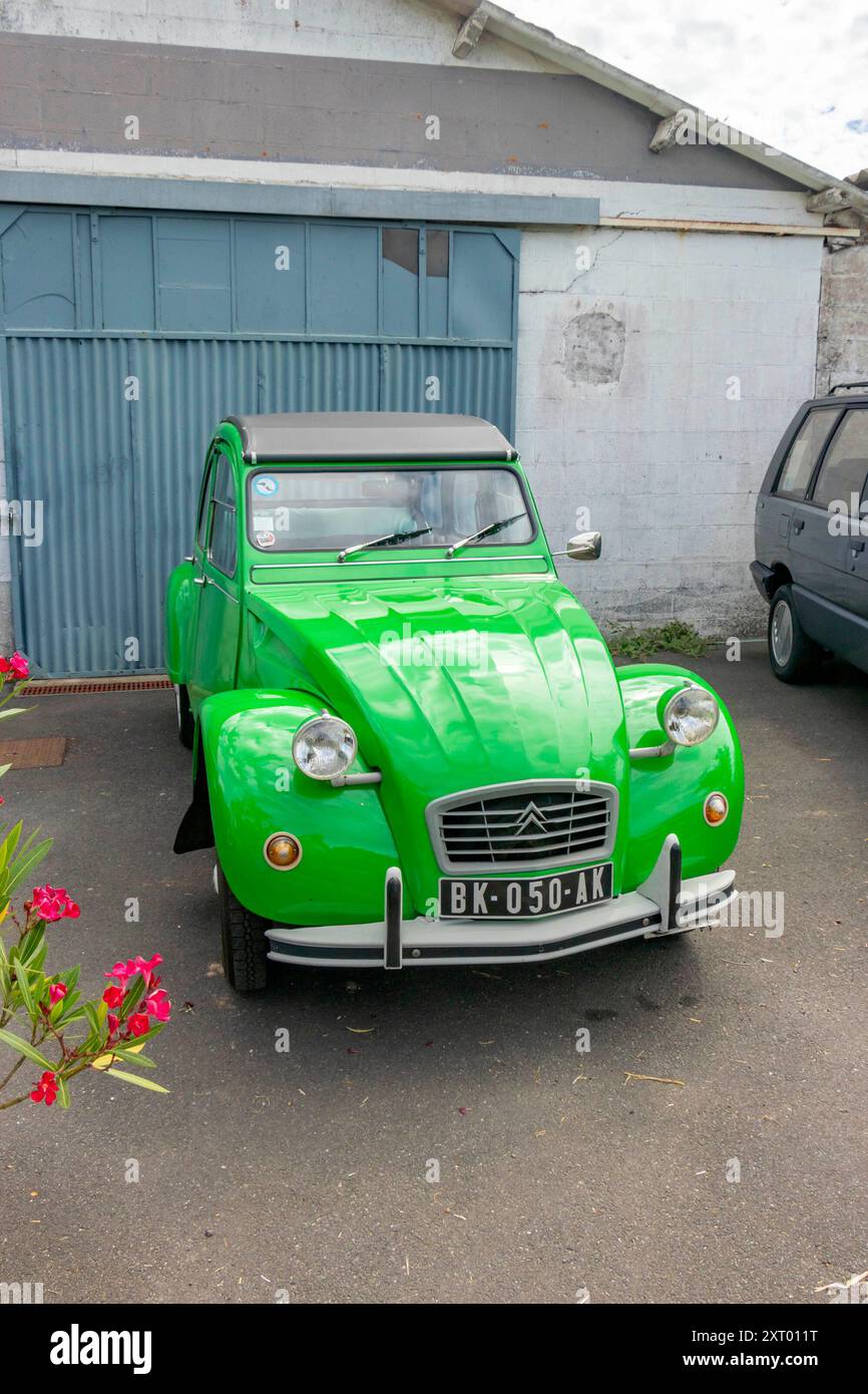 vintage classic green Citroen 2CV s outside a garage Paizay-le-Sec ...