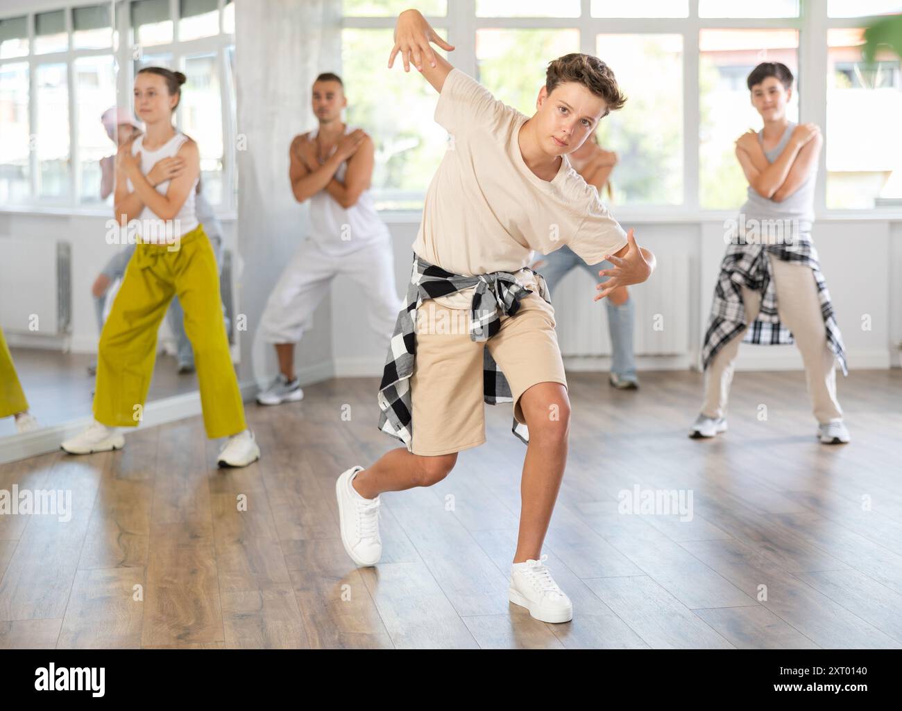Teenage boy dancing hip-hop against background of group members Stock ...