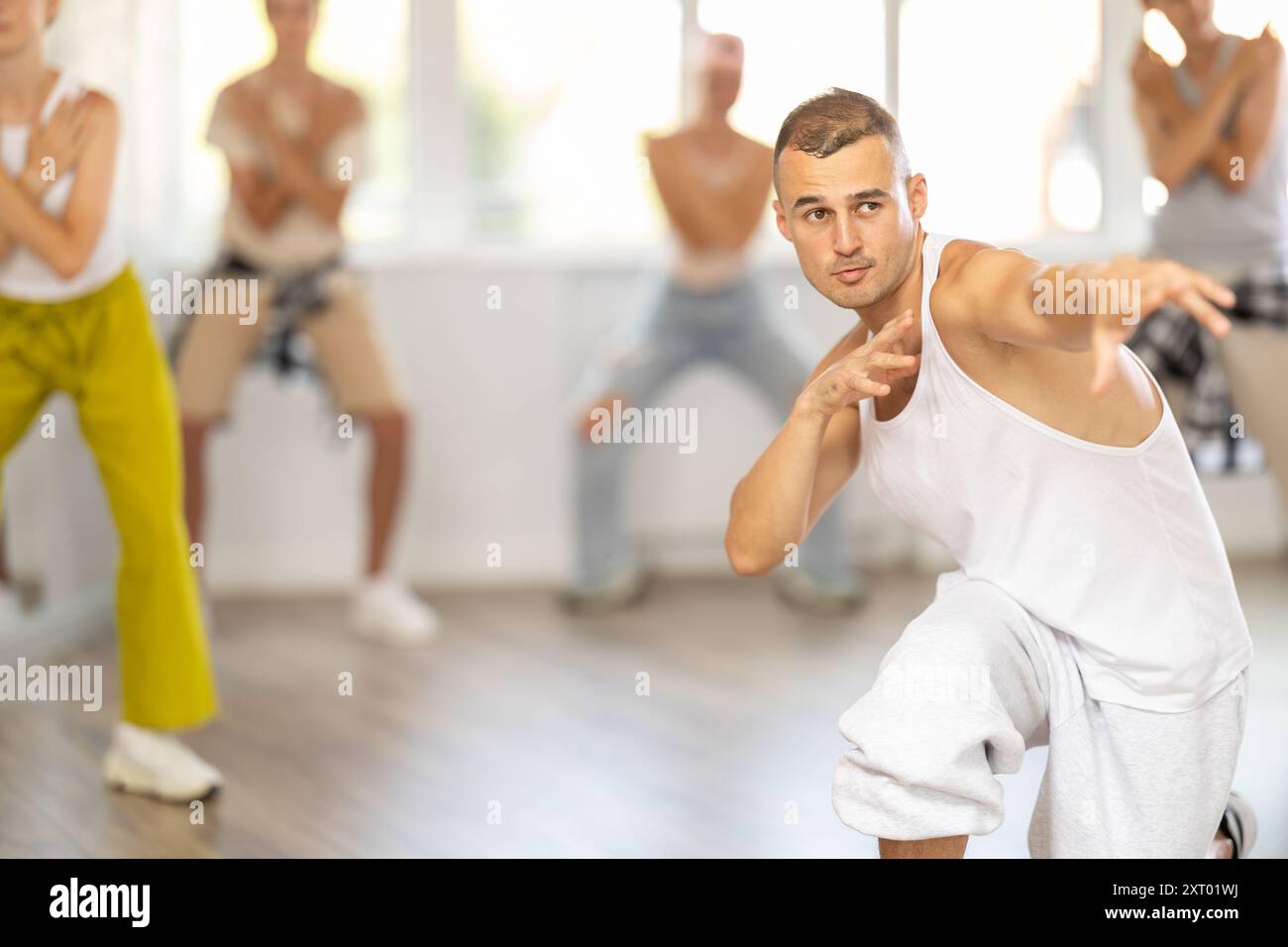 Young guy dancing hip-hop against background of group members Stock ...