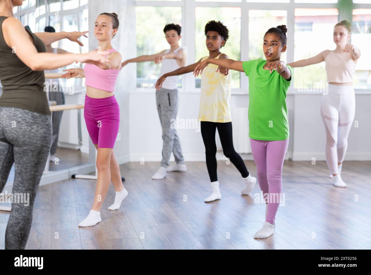 Group of teenage dancers training ballet in studio Stock Photo - Alamy