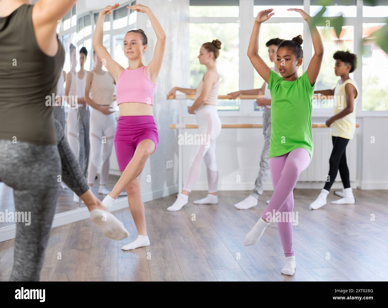 African american teen girl participating in beginner group ballet class ...
