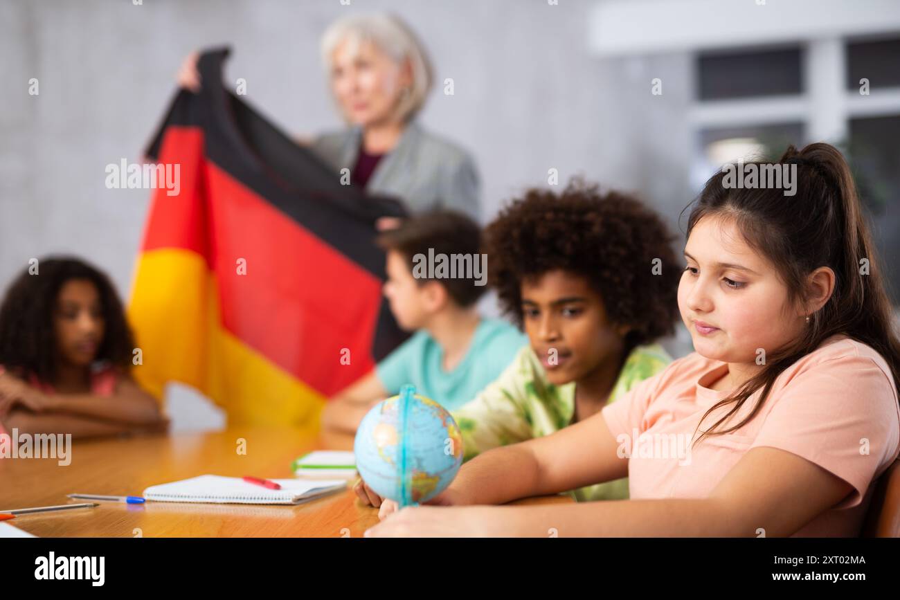 Female teacher showing german to kids in geography class Stock Photo ...