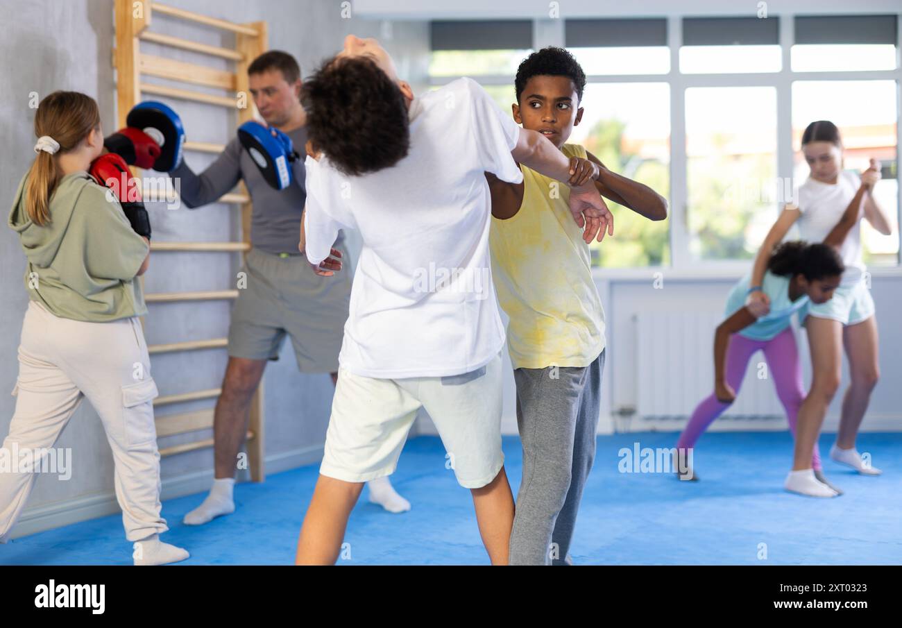 Two boys practicing self-defense techniques Stock Photo - Alamy