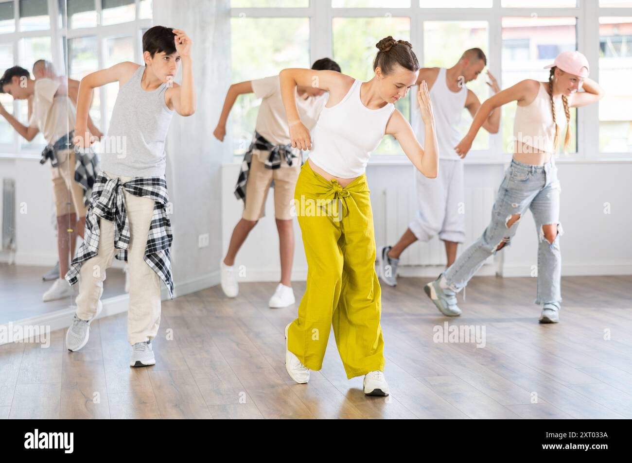 Teenage girl practicing hip hop slide moves in training hall Stock ...