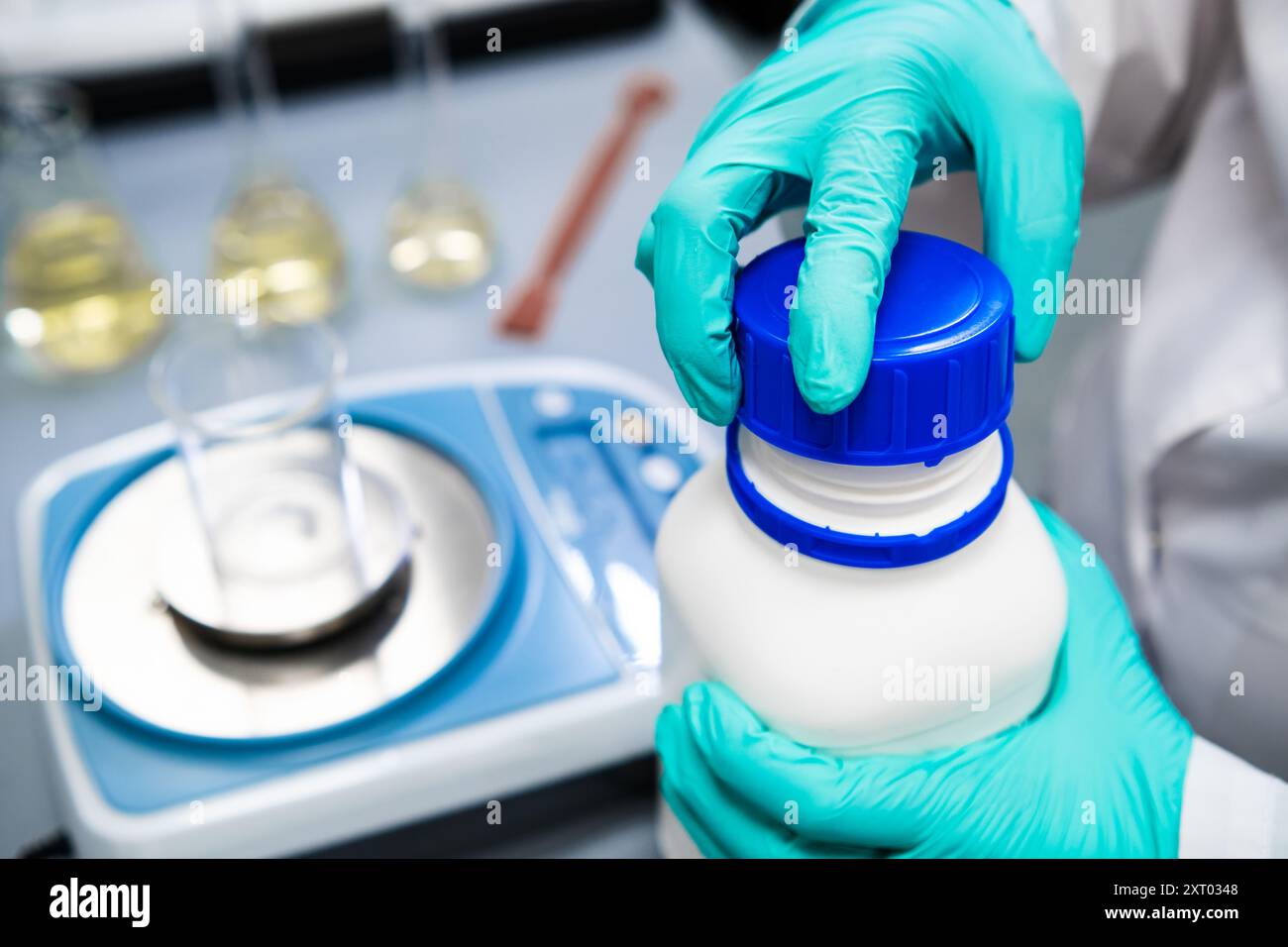 Close-up researcher opens the bottle with the reagent in a chemical ...
