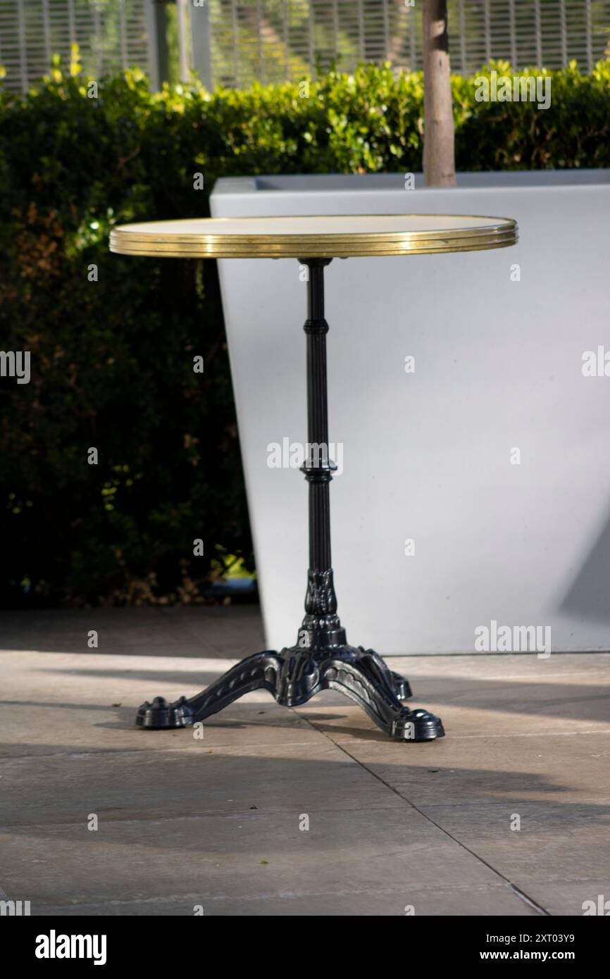 bistro table with wrought iron stand Stock Photo - Alamy