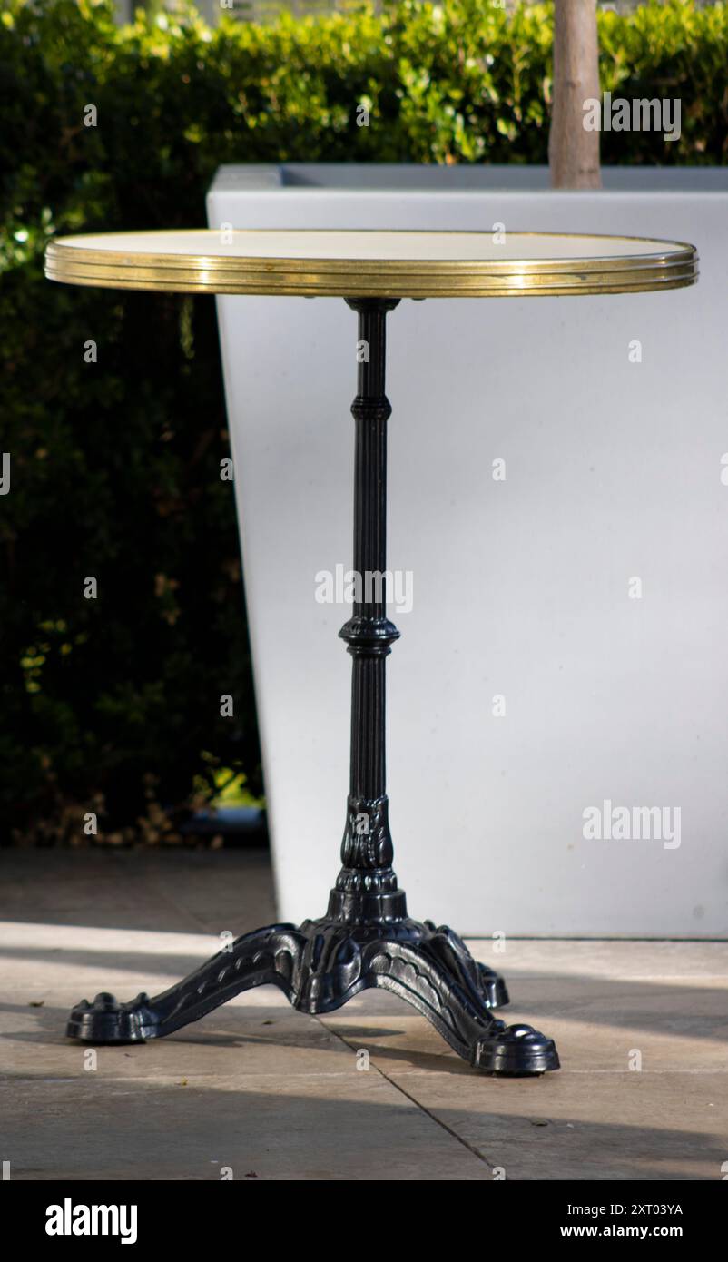 bistro table with wrought iron stand Stock Photo - Alamy