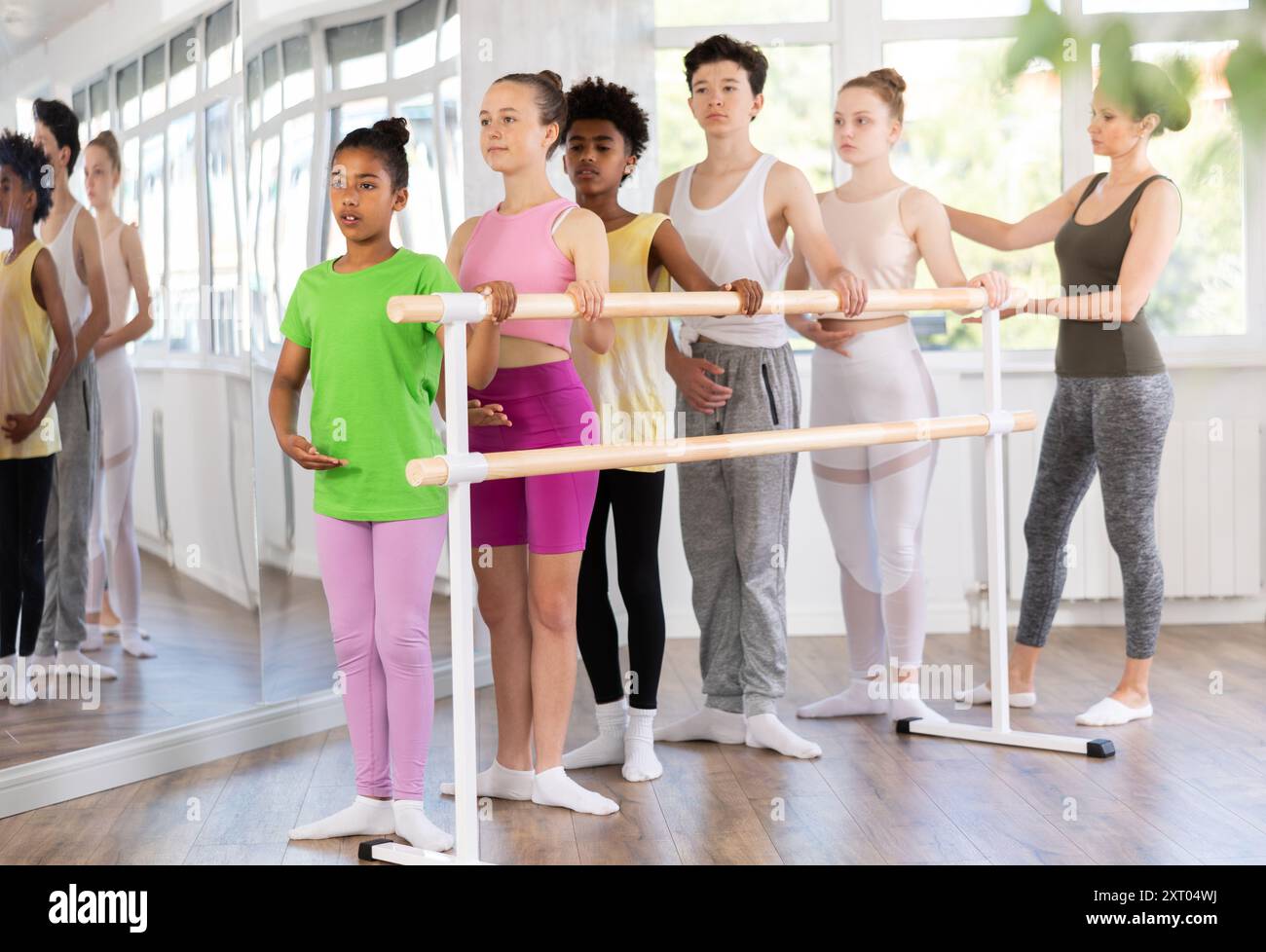 Teenage girl practicing ballet positions in dance studio Stock Photo ...