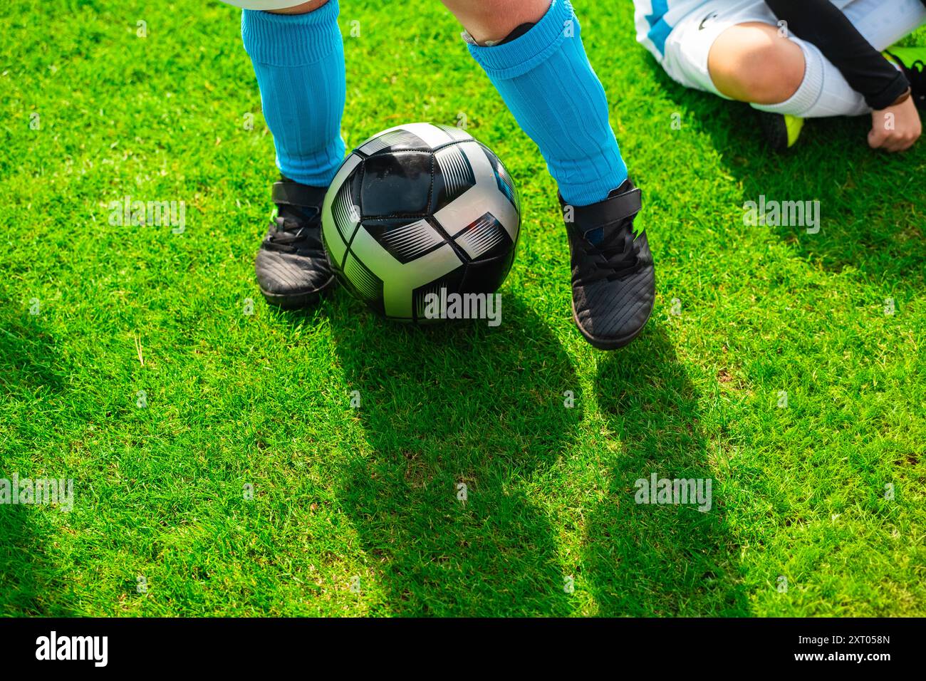 Black Football Played by a Soccer Player Close to the Football Shoes ...