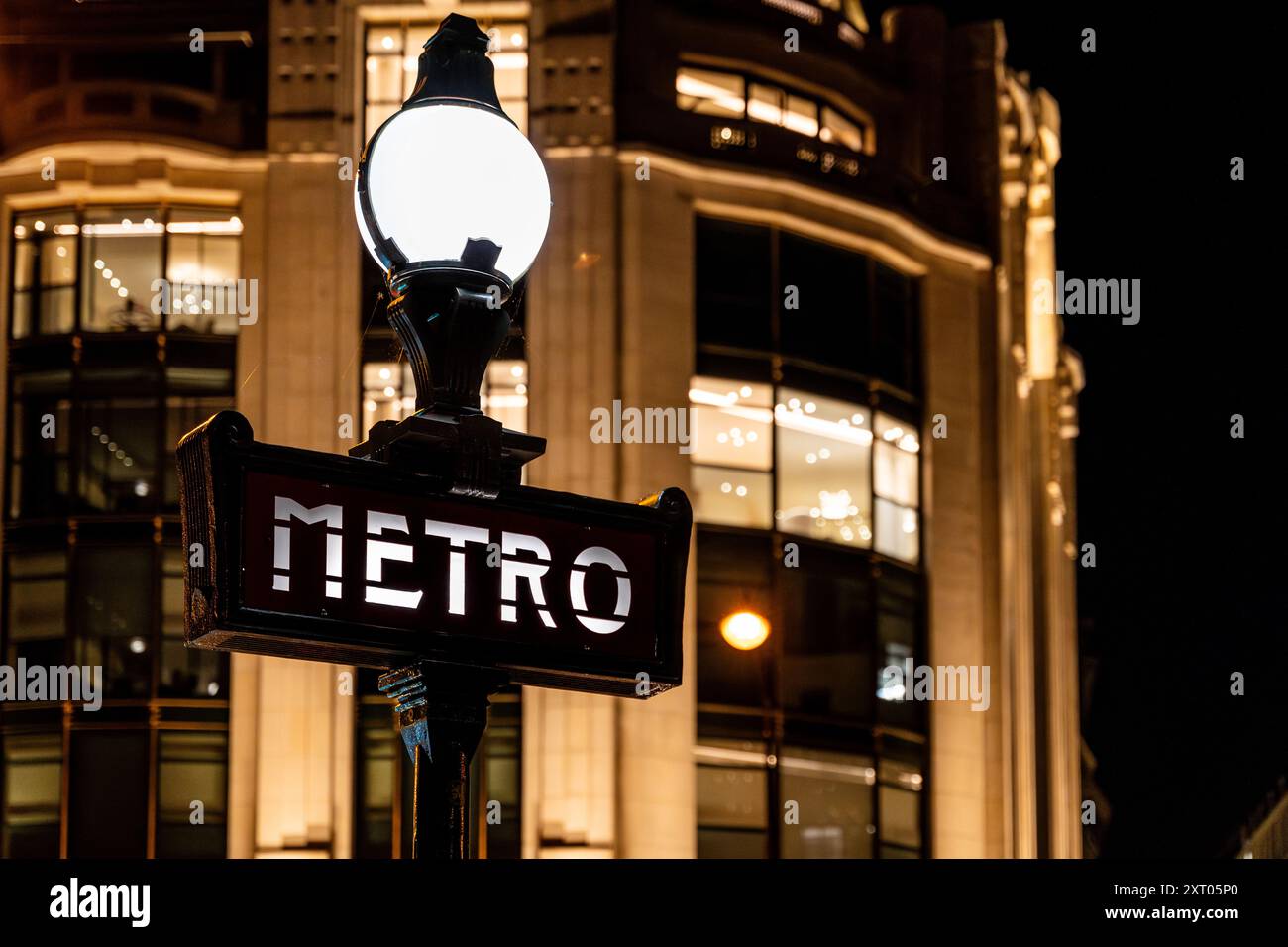 Vintage "Metro" (subway) red sign and globe street lamp post with light ...