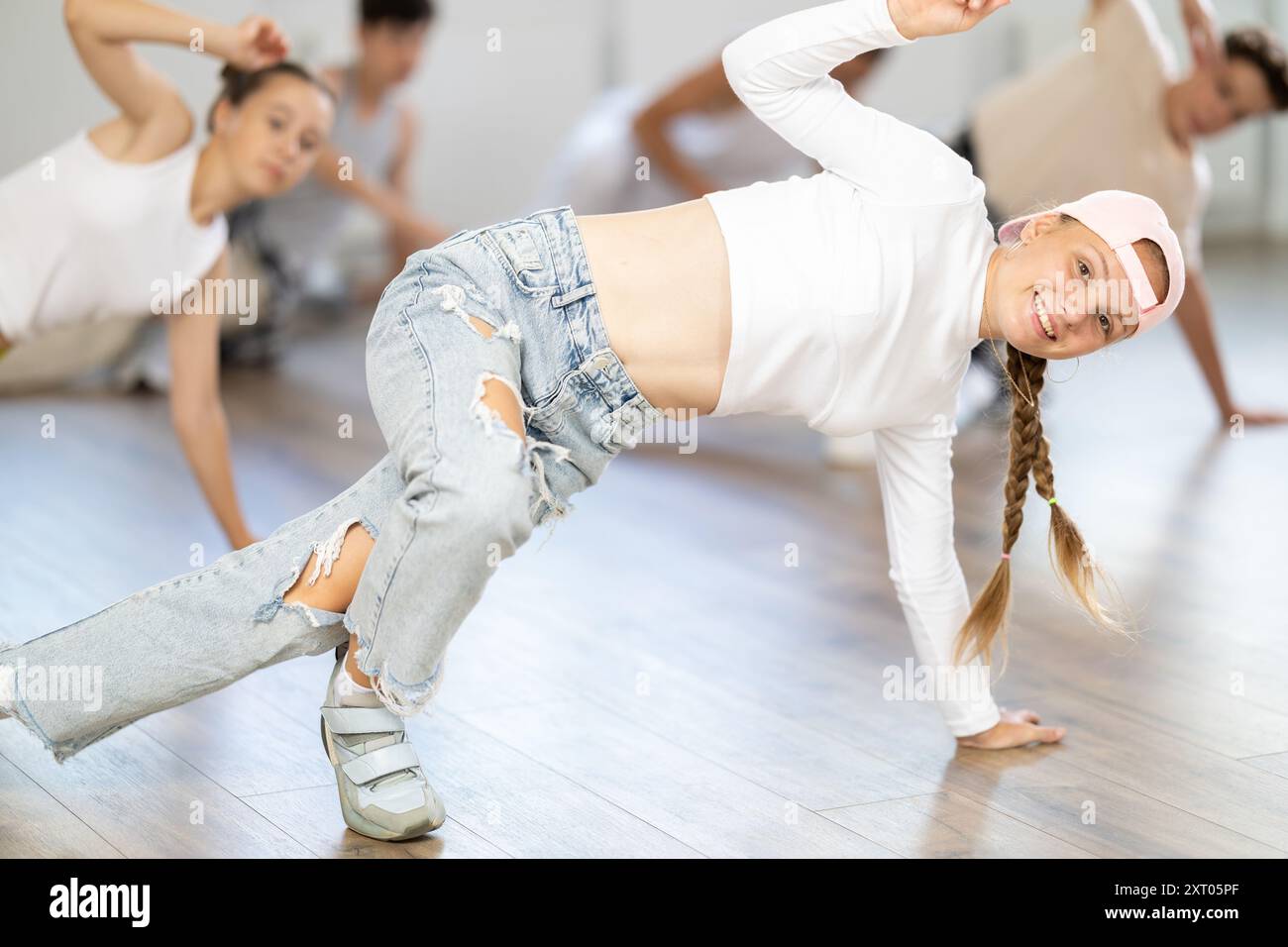 Girl in baseball cap with two hair pigtails with group of teenage ...