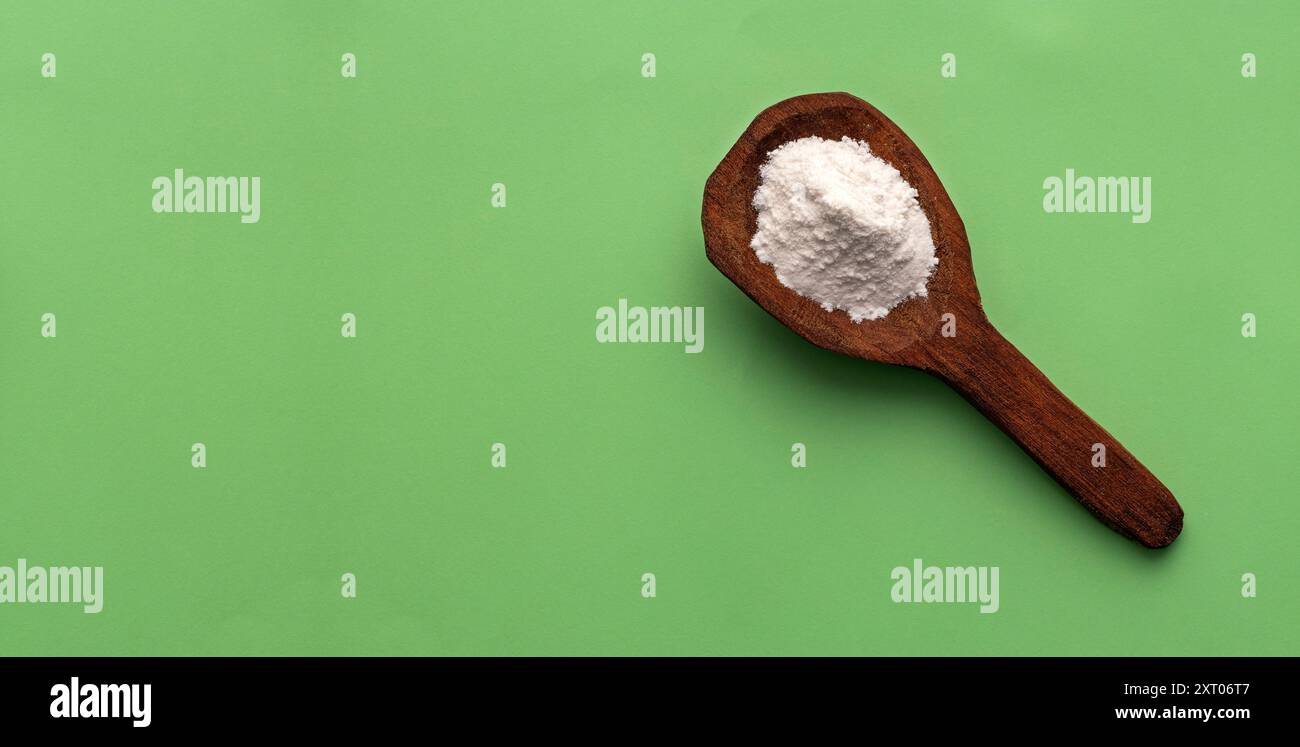 Baking Soda - Crystalline Solid compound in spoon. Green background ...
