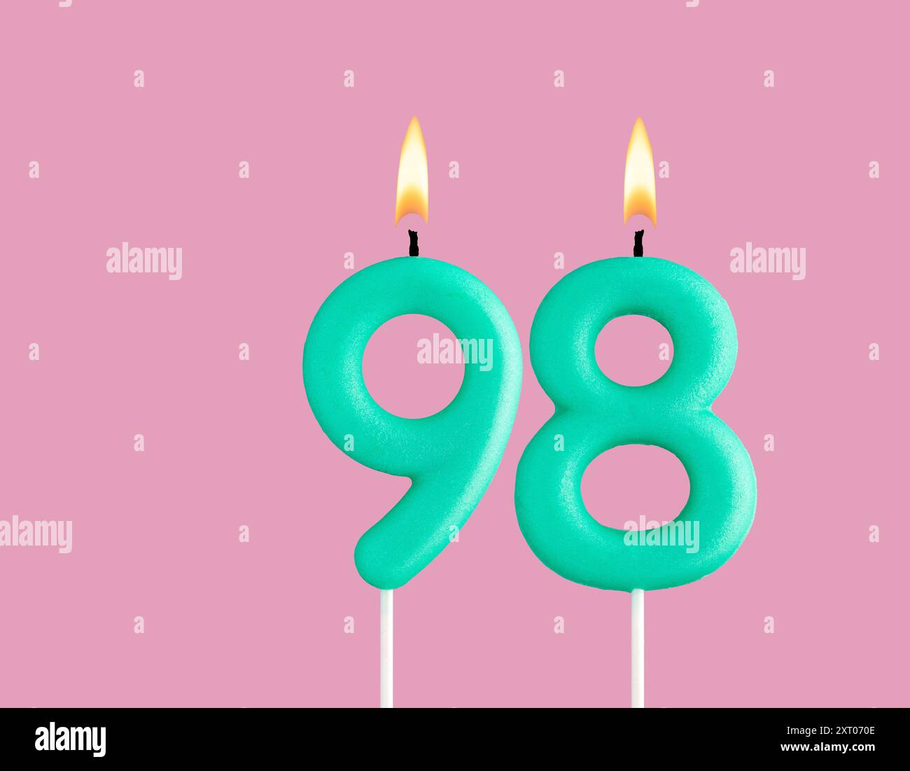 Green candle number 98 - Birthday card on pastel pink background Stock ...