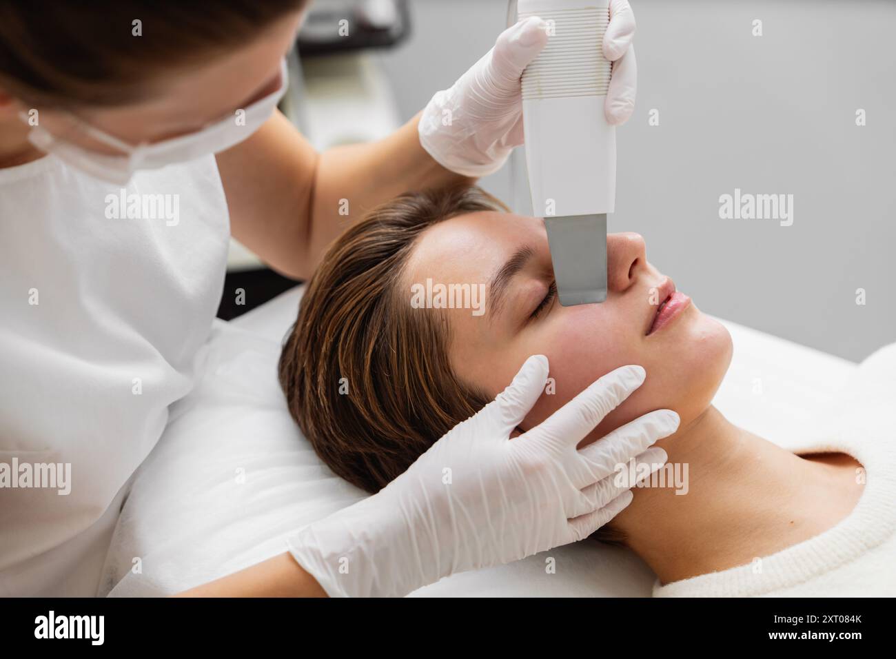 Aesthetician performing facial treatment on a client in a modern ...