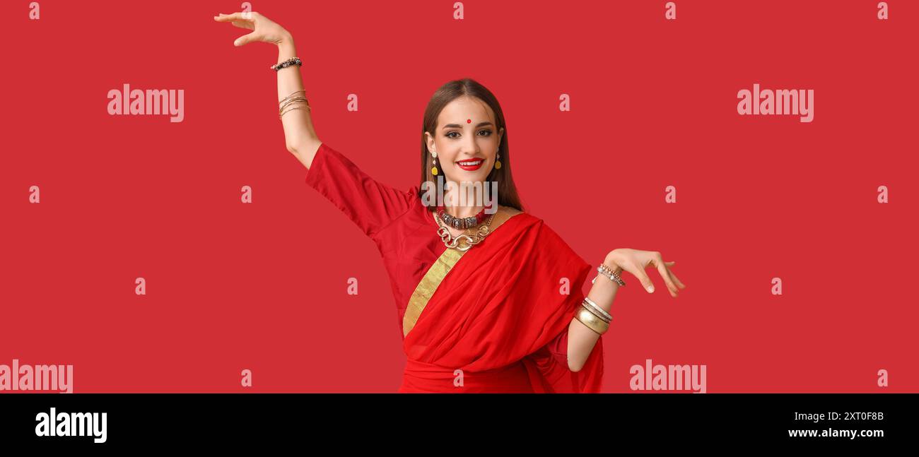 Beautiful dancing Indian woman in sari on red background Stock Photo ...