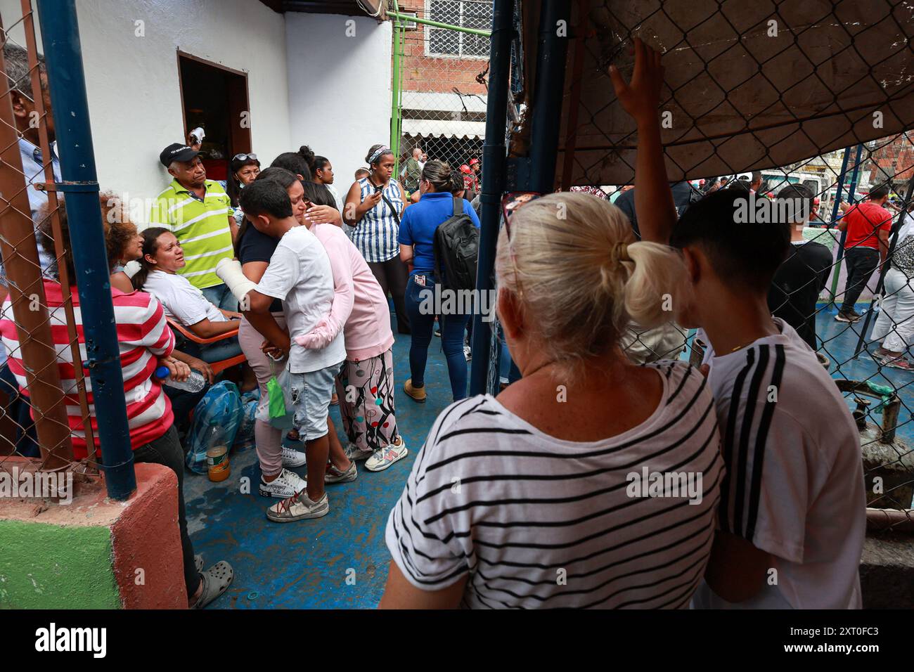 Caracas, Venezuela. 12th Aug, 2024. Survivors stand together after an ...