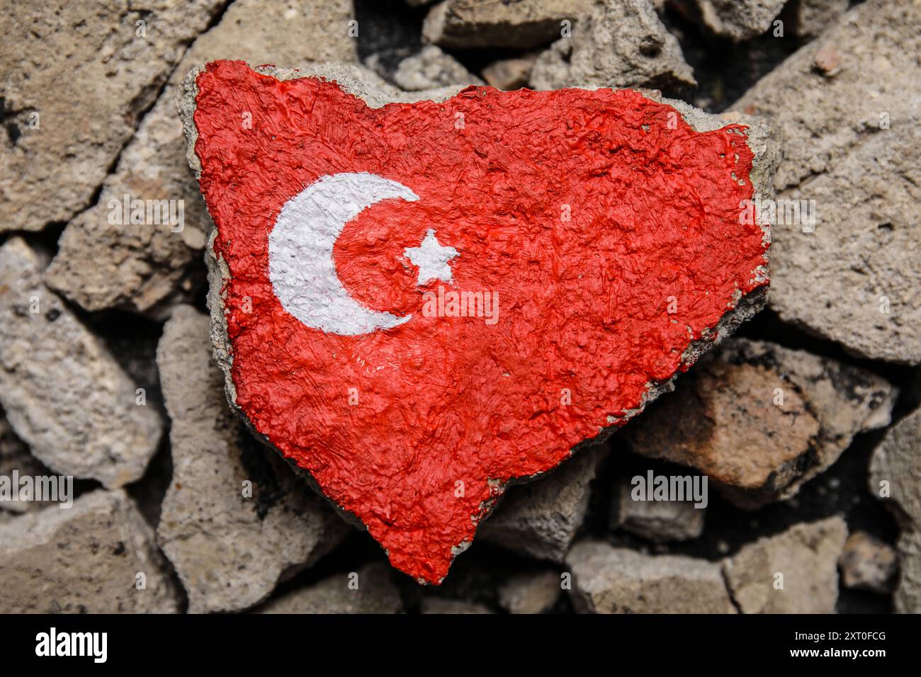 Stone debris with painted Turkish flag on dark background. Turkey ...