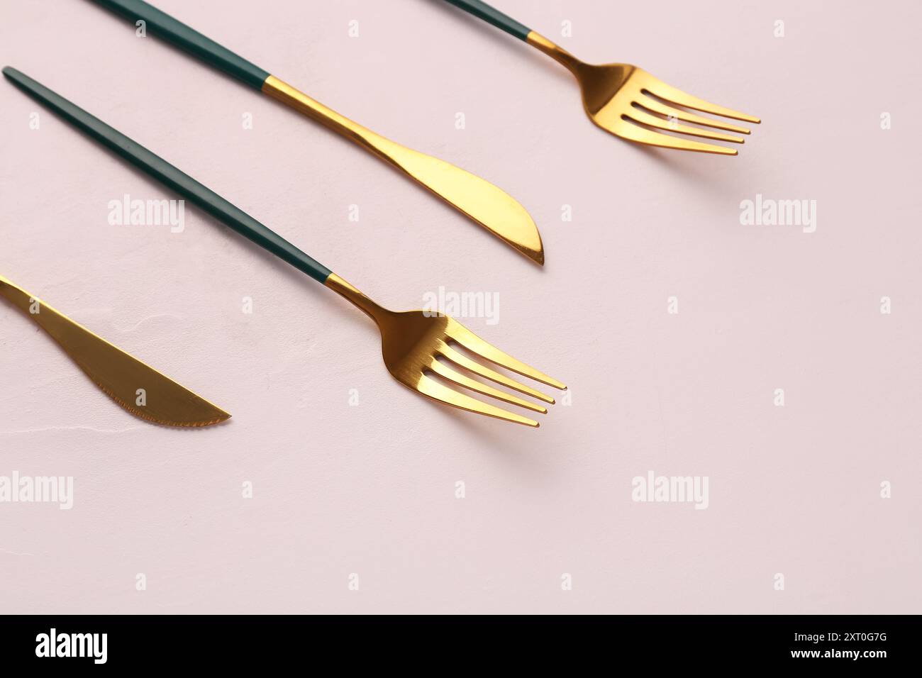 Golden forks and knives with green handles on white background Stock ...