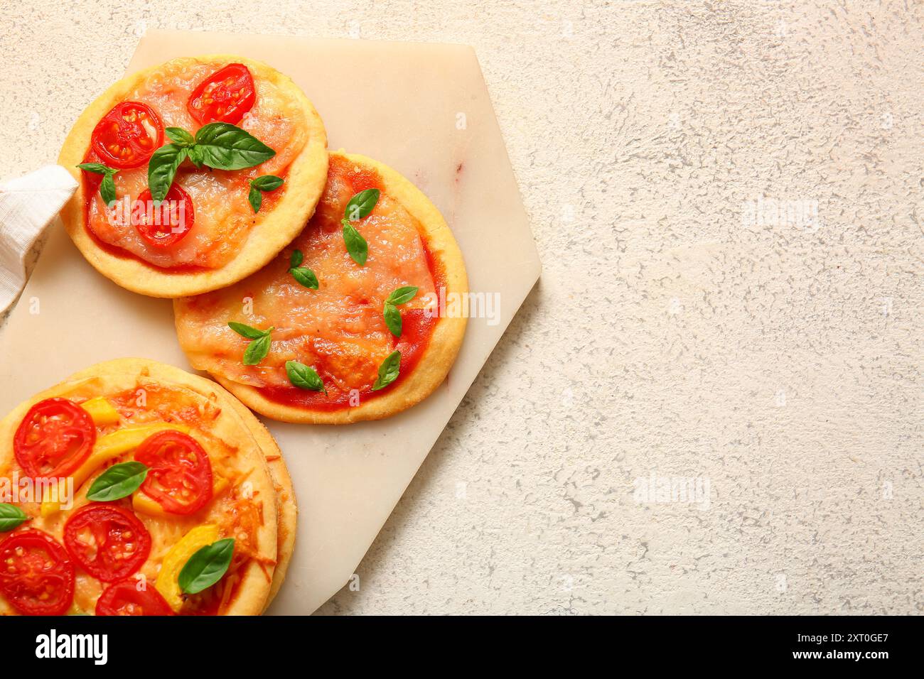 Board with different tasty mini pizzas on white background Stock Photo ...