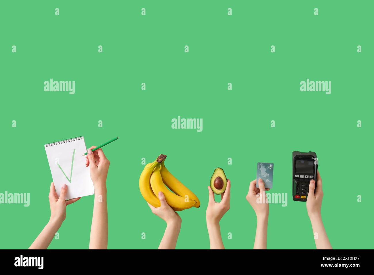 Hands holding fresh bananas, avocado, payment terminal and notebook ...