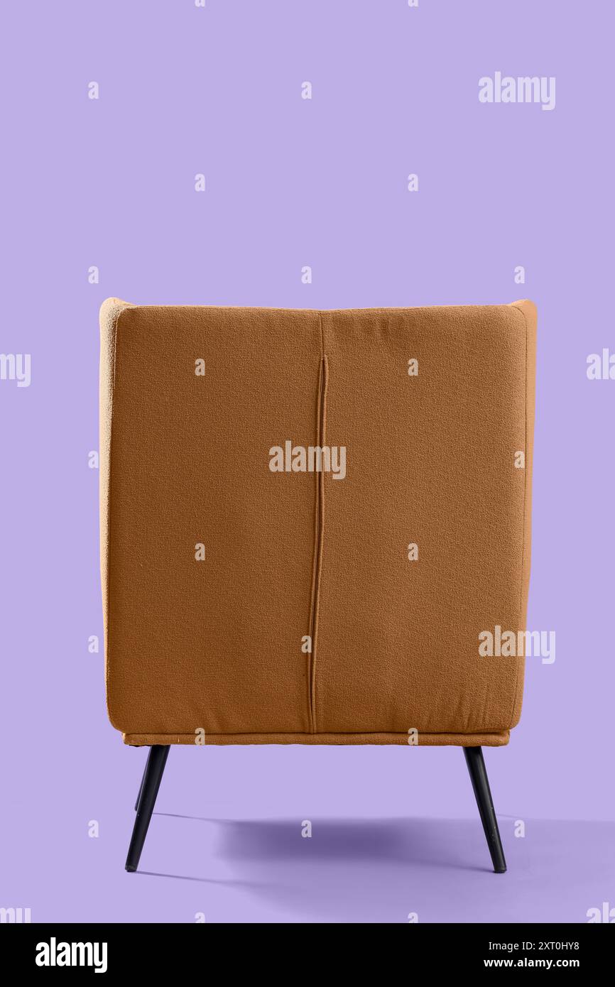 Beautiful brown armchair on lilac background, back view Stock Photo - Alamy