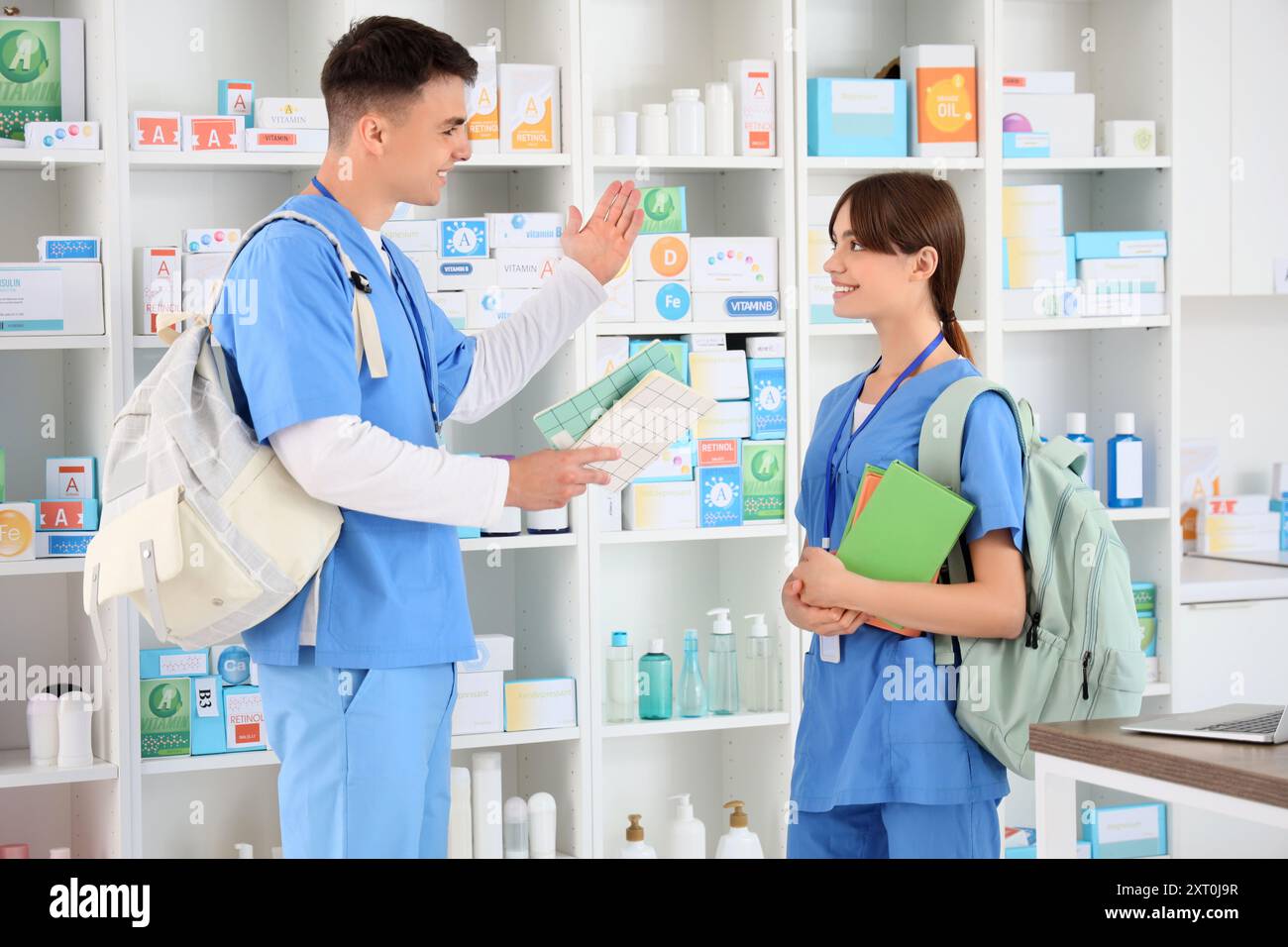 Medical students with books talking at university Stock Photo - Alamy