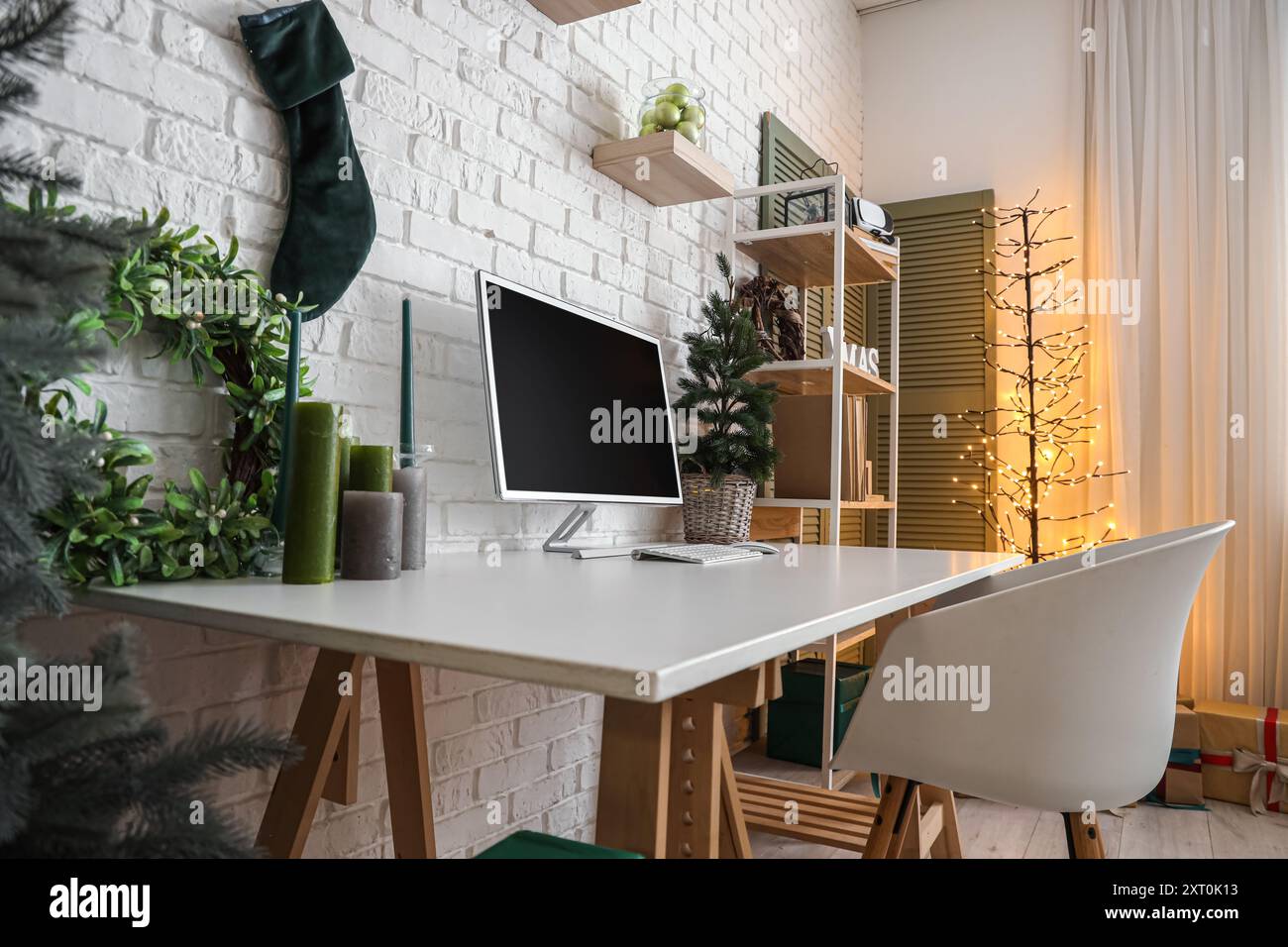 Interior of programmer's office with workplace, Christmas tree and ...