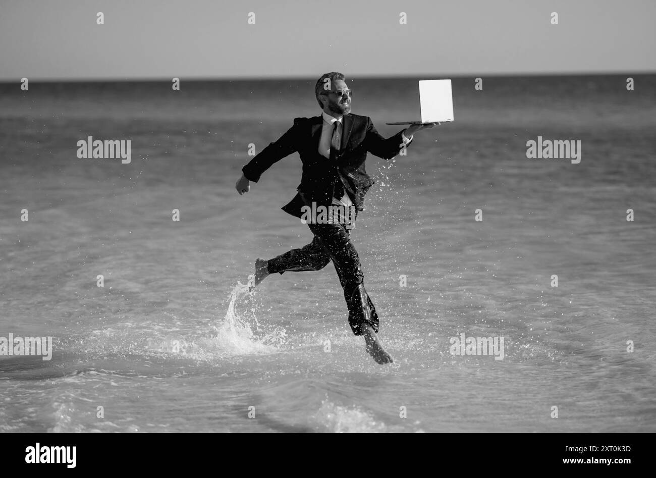 Man in suit running into distance Black and White Stock Photos & Images ...