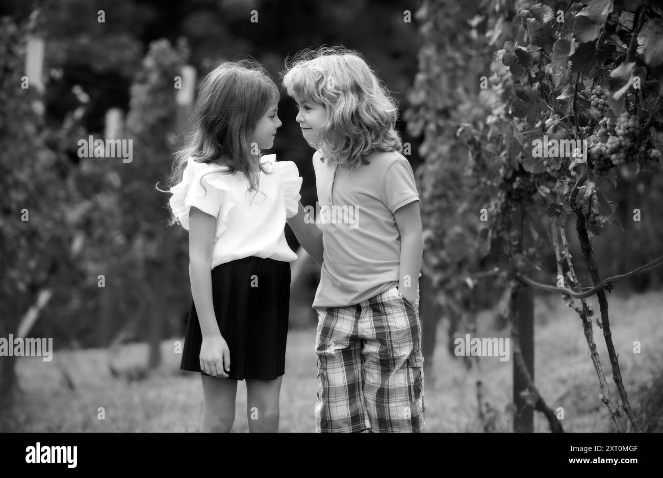 Little boy and girl best friends hugging in garden. Kids kissing each ...