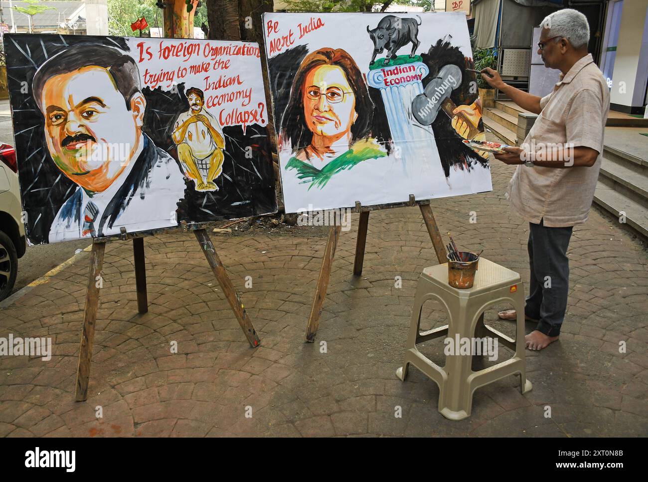 A teacher from Gurukul School of Art makes a painting of Gautam Adani ...