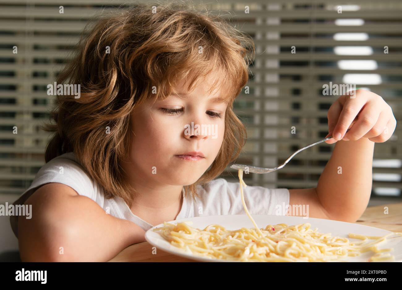 Portrait of little boy eating pasta, spaghetti. Concept of kids face ...