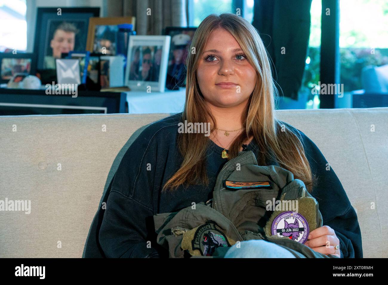 Gwyneth Collart sits for a portrait while holding the uniform of her ...