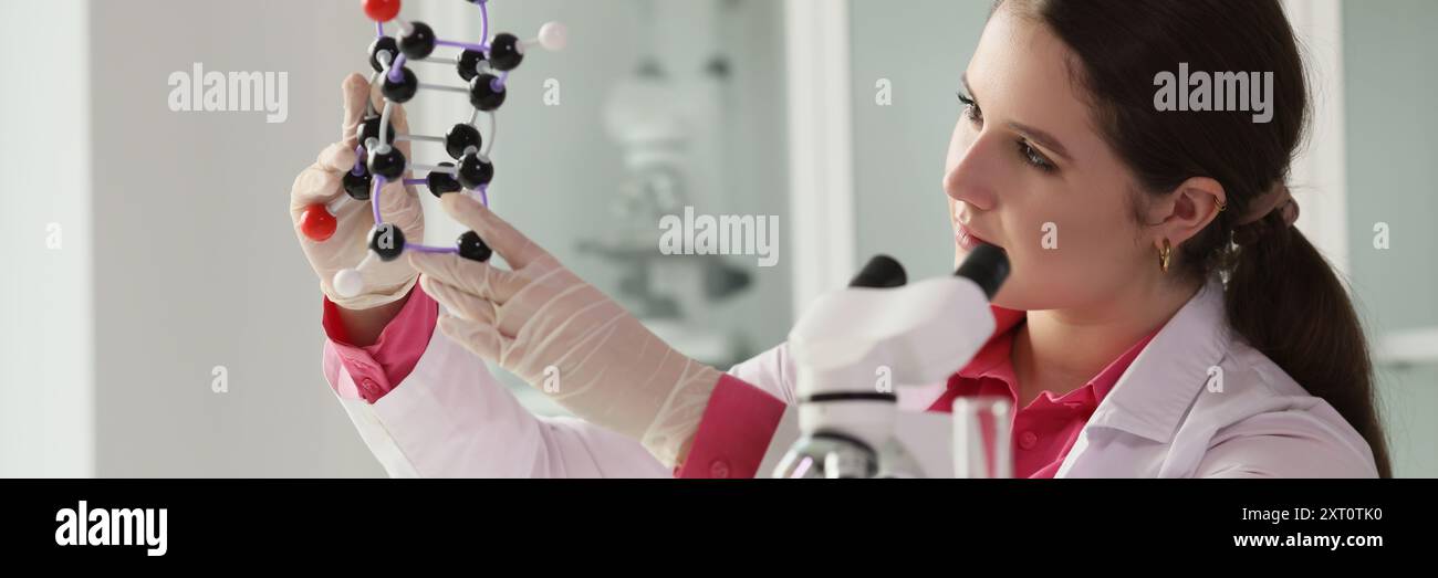 Scientist woman holding model of molecule in laboratory Stock Photo - Alamy
