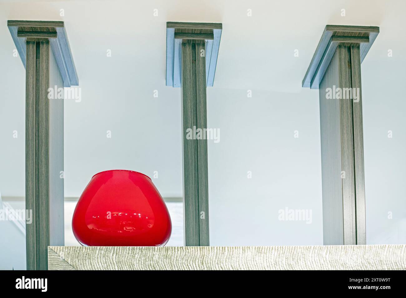 red ceramic vase on a stylish modern rack in a home interior Stock ...