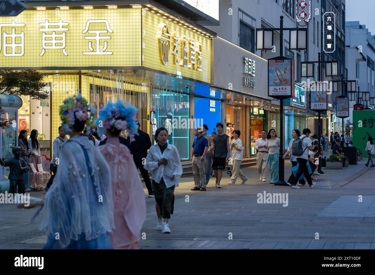 Suzhou, China - June 11, 2024 : People walk down a busy city street ...