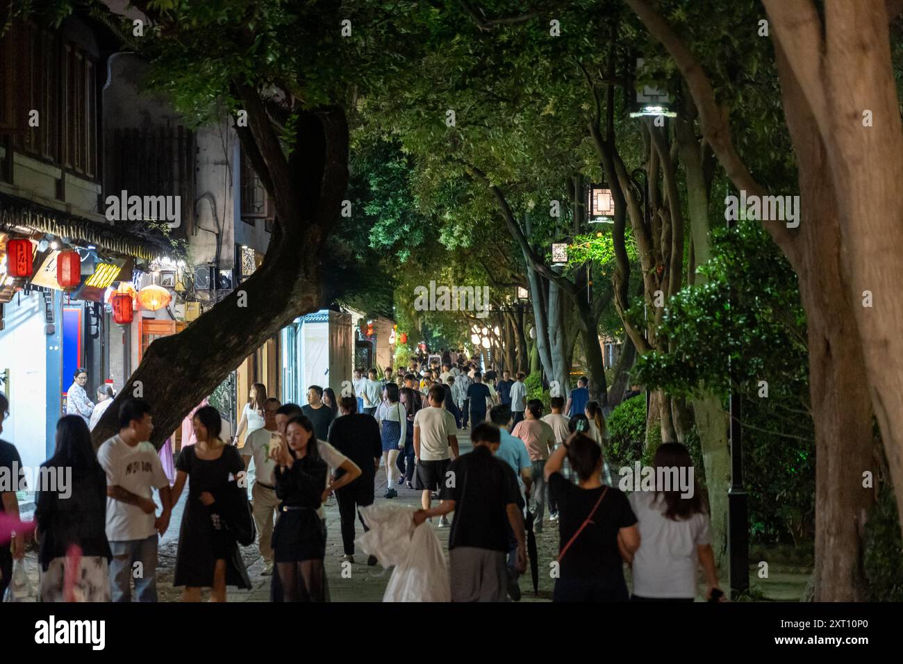 Suzhou, China - June 11, 2024 : A crowd of people walks down a narrow ...