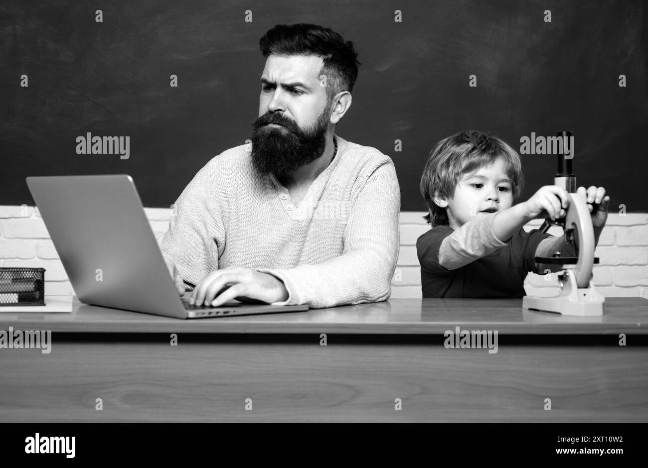 Father and son. Preschool pupil. Teacher teaches a student to use a ...