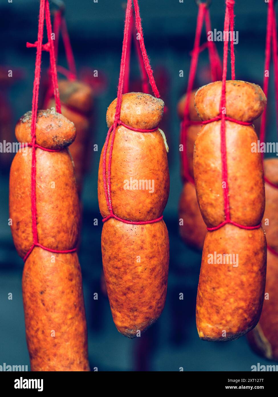 Hanging rows of traditional Spanish sobrasada sausages tied with ...