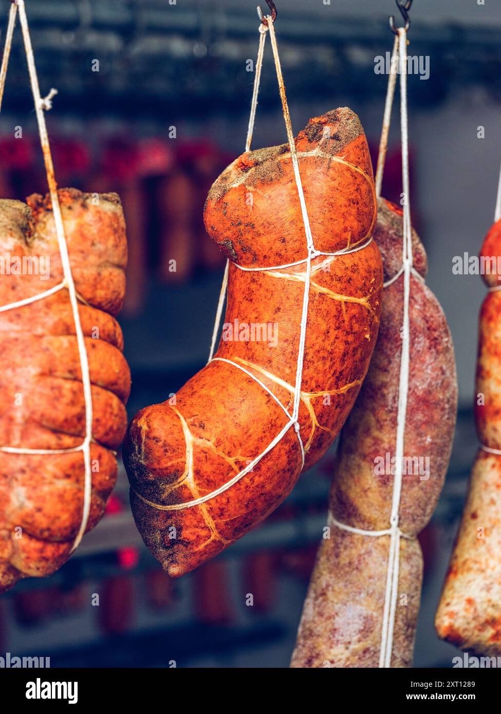 Traditional Spanish sobrasada sausages hanging for curing, showcasing ...