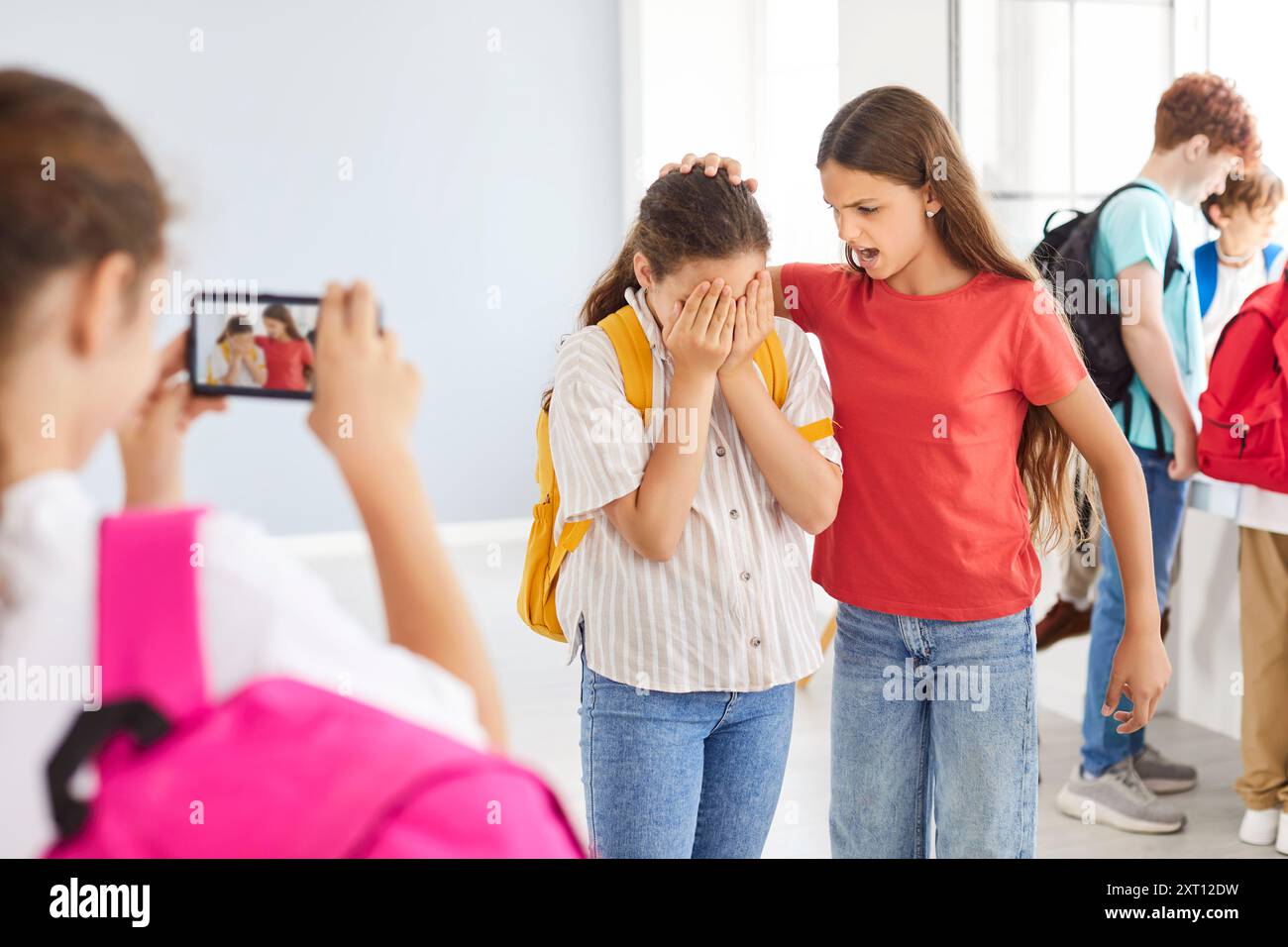 School bullying. Female victim student bullied and filmed by group of ...