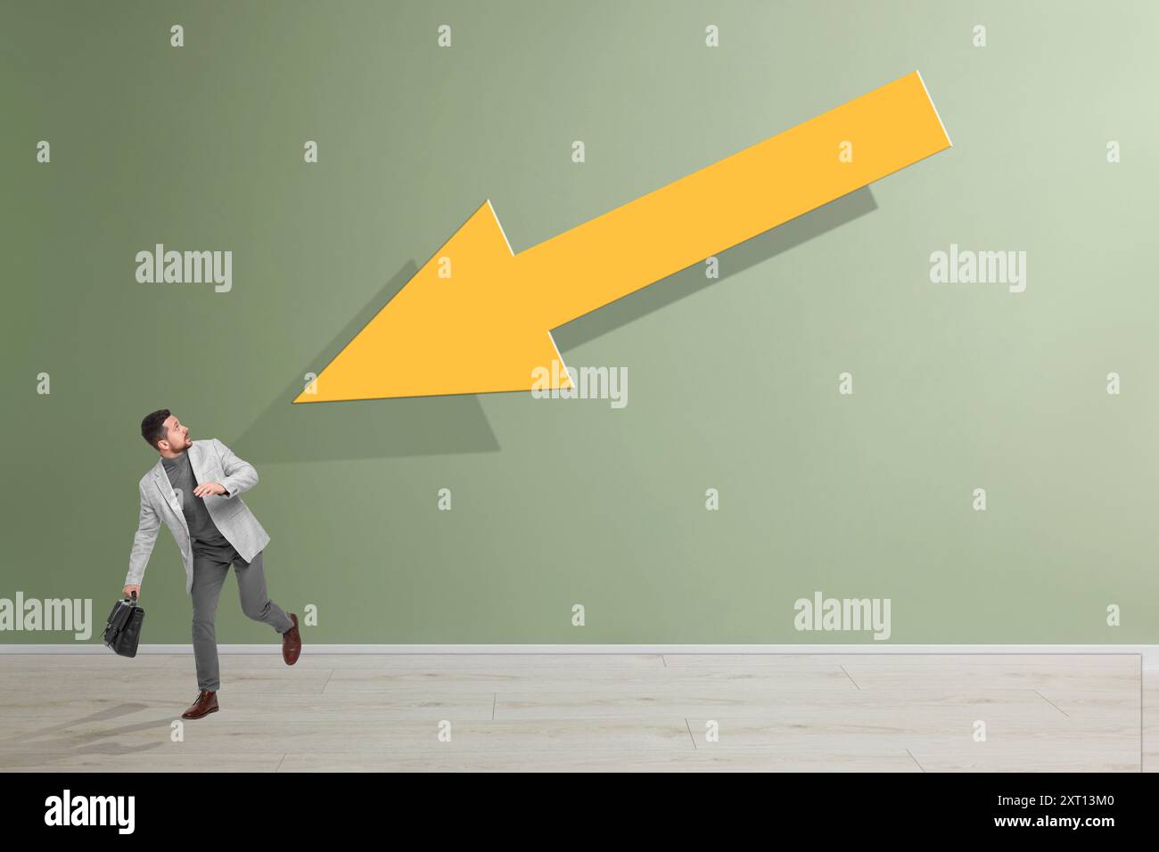 Small businessman running away from huge arrow on light green ...
