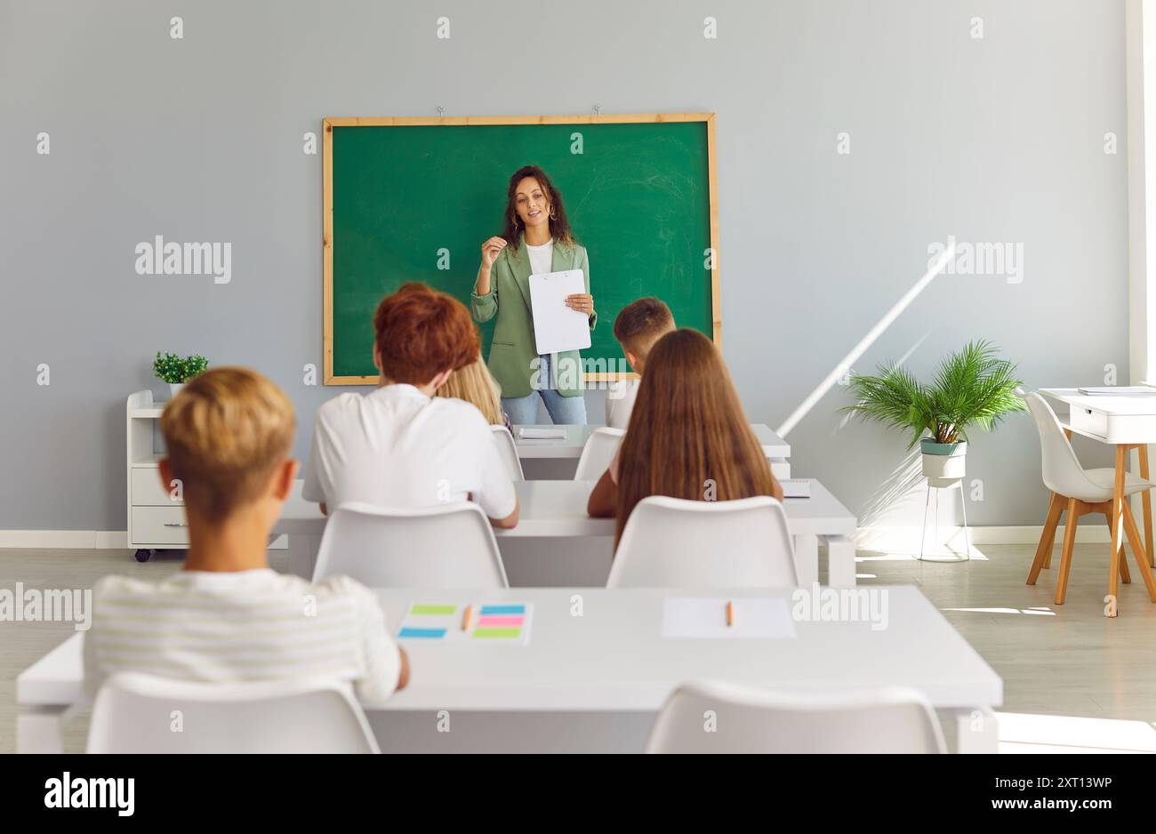 Teacher Conducting Lesson For Students In Classroom Stock Photo - Alamy